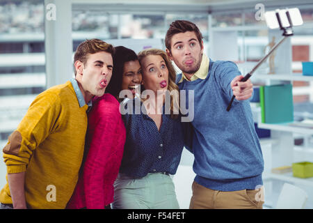 Smiling creative team posing for a selfie Stock Photo - Alamy