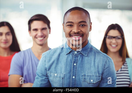 Young creative team looking at camera Stock Photo - Alamy