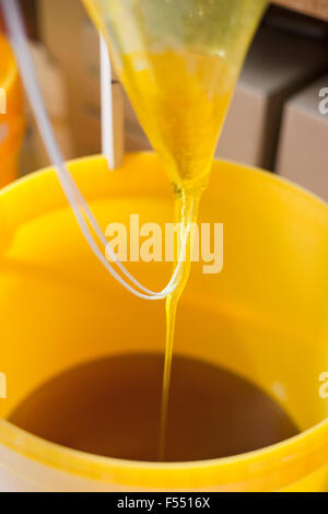 close up of honey being poured into a silver spoon, honey is a natural ...