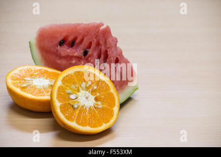 pieces of orange, a little knife cut orange to two pieces on the ...