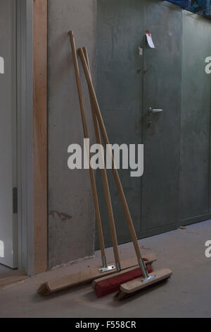 A broom is leaning against a wall in a room Stock Photo - Alamy