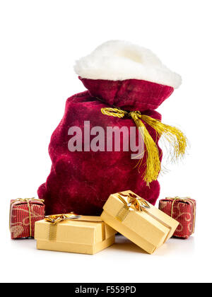 Santa Claus with bag full of gifts in room decorated for Christmas ...
