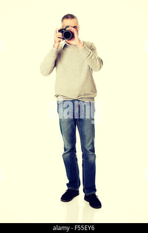 man photographing hold photo camera. photo of man photographing with ...