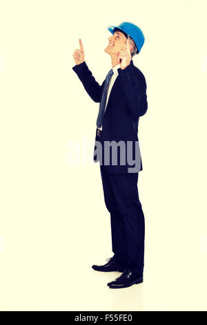 Businessman engineer pointing up Stock Photo - Alamy