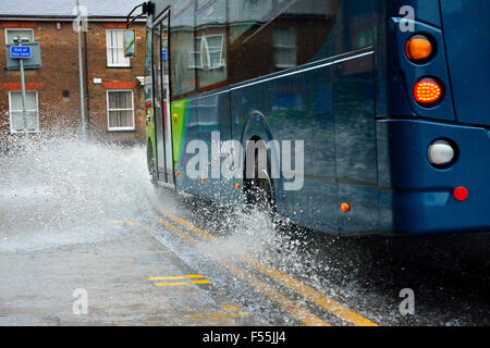 Bus driving through rain puddles in Luton, Bedfordshire, England Stock ...