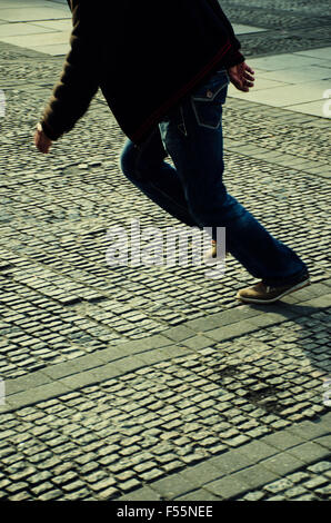 Mysterious man running on a cobbled street Stock Photo - Alamy