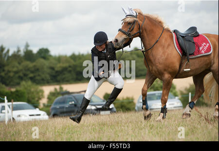 horse rider about to fall off a pony during showjumping Stock Photo - Alamy