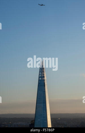 Airplane over a glass skyscraper, The Shard, City of London, England ...