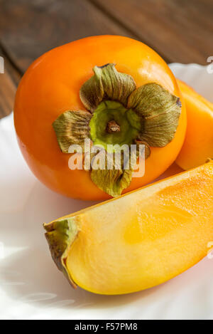 fresh natural kaki fruits on white background Stock Photo - Alamy
