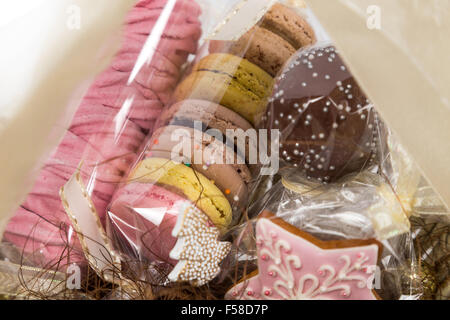 sweet christmas present in basket with pastry macaroons and decor Stock ...