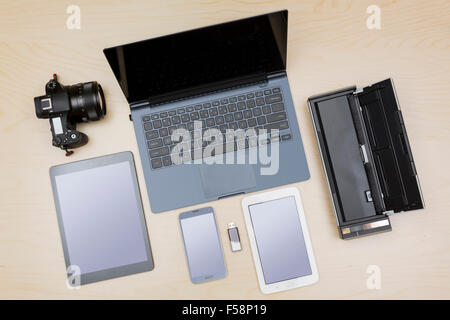 Overhead view of workspace with laptop, phone, glasses and notepad ...