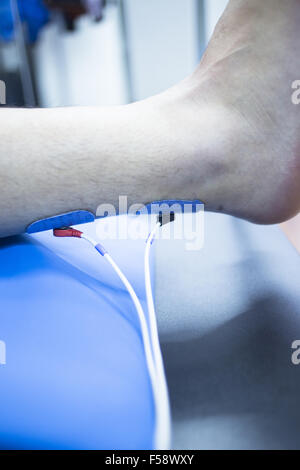 Patient knee, leg, thigh and calf in physiotherapy electrical impulse ...