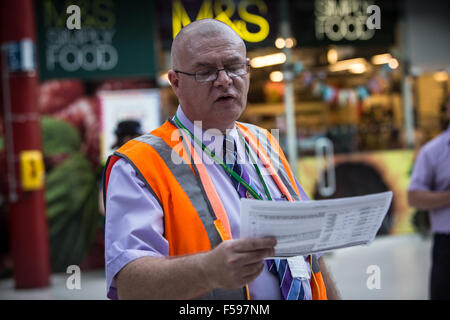 Station manager signaling train departure on Platform at Swansea ...