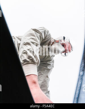 A Scene of Crime Officer (SOCO) wearing protective mask and goggles ...