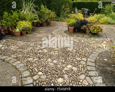 Ornate cobble stone patterned patio pathway, Barnsdale Gardens, Rutland ...
