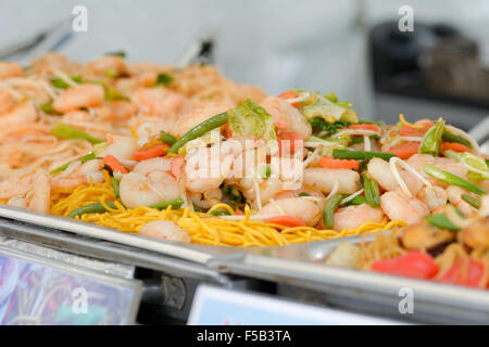 Row of Chinese food stall with plates of various foods such as ...