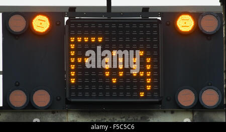 An illuminated motorway matrix sign which reads 'FOG SLOW DOWN' on the ...