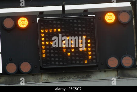 An illuminated motorway matrix sign which reads 'FOG SLOW DOWN' on the ...