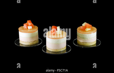 Three small cakes decorated with different fruits Stock Photo - Alamy