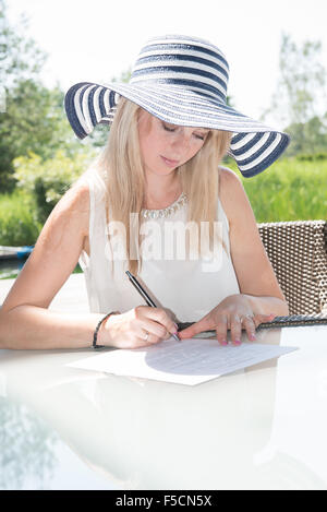 Portrait of beautiful woman writing on the background of two ...