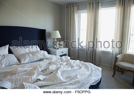 Bedroom with an unmade bed Stock Photo - Alamy