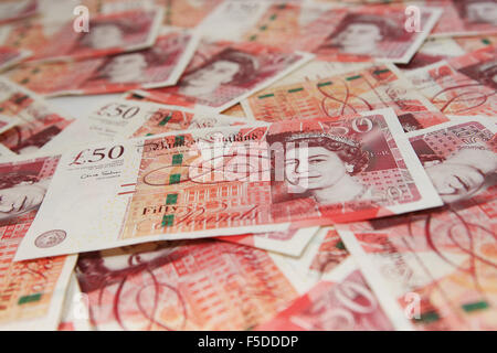 Pile of £50 notes spread out Stock Photo - Alamy