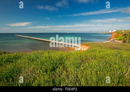 Jetty at Ardrossan, spearing out from red cliffs to turquoise ocean ...