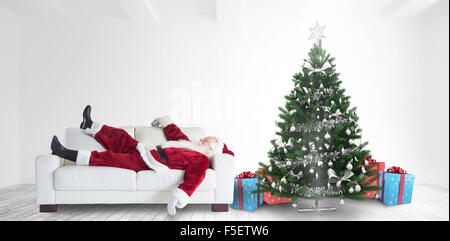 Composite image of santa claus taking a nap Stock Photo - Alamy