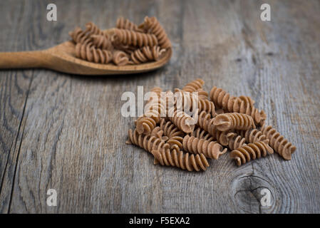 Wholegrain, spelt fusilli pasta with a wooden spoon Stock Photo - Alamy