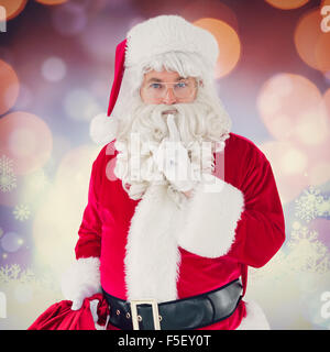 Composite image of santa holding sack and keeping a secret Stock Photo ...