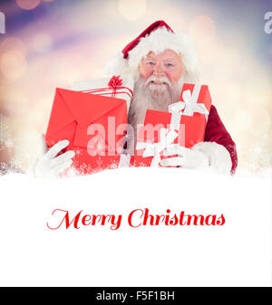 Composite image of santa carries a few presents Stock Photo - Alamy