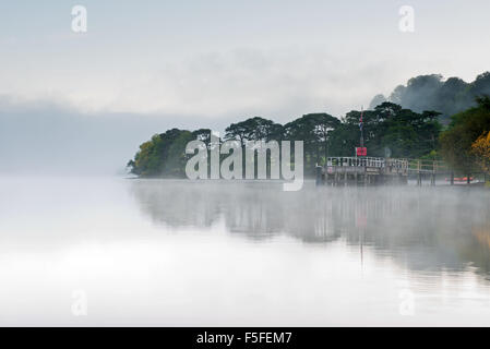 The Pier at dawn during mist on Ullswater Lake, Howtown, Lake District ...