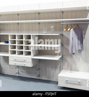Modern dressing room interior with rack of stylish women's clothes ...