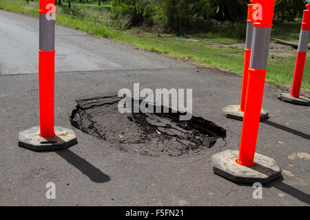 Broken asphalt pavement caused by rain and subsidence due to a lack of ...