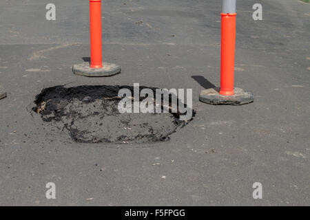 Broken asphalt pavement caused by rain and subsidence due to a lack of ...