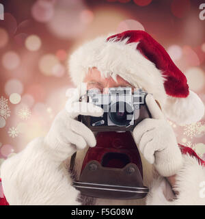 Composite image of santa is taking a picture Stock Photo - Alamy