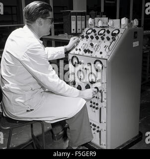 1950s historical, white coated engineer showing young male aviation ...