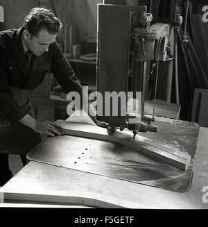 1950s historical, male carpenter using a Wadkin electric woodworking ...