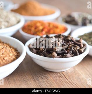 Various spices on white wooden background Stock Photo - Alamy