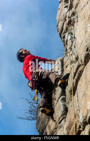 A man climbing up a rock face, Al Hajar mountains, Oman, Asia Stock ...