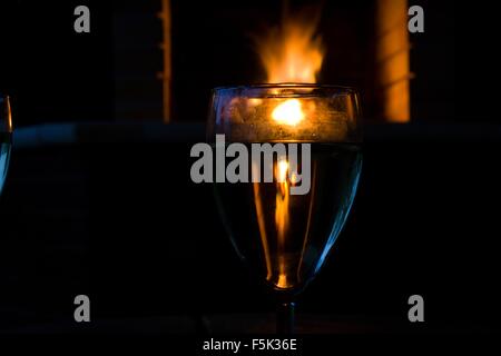 A relaxing evening - glass of wine fireside Stock Photo - Alamy