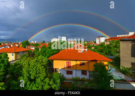 Beautiful double rainbow over the city Stock Photo - Alamy