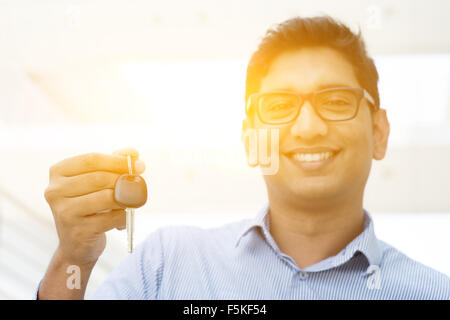Young Asian Indian estate agent or salesman holding a key, India male ...