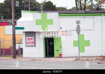 A medical green cross marijuana sign on the exterior of a dispensary in ...
