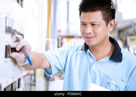 Man at control panel in flexible electronics plant Stock Photo - Alamy
