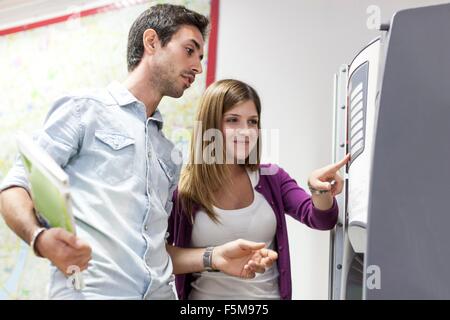 young man using a vending machine Stock Photo - Alamy