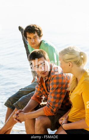 High angle view of female friends holding cigarettes while talking at ...
