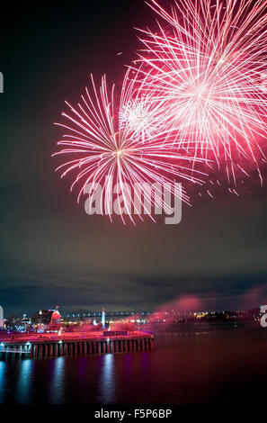 Red fireworks explode in Montreal fireworks festival in dark sky ...