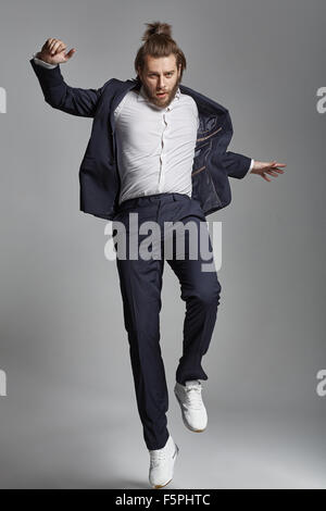 Young black man doing victory sign and peace gesture clueless and ...