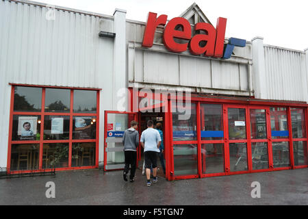 A logo sign outside of a Real (real,-) hypermarket retail store in ...